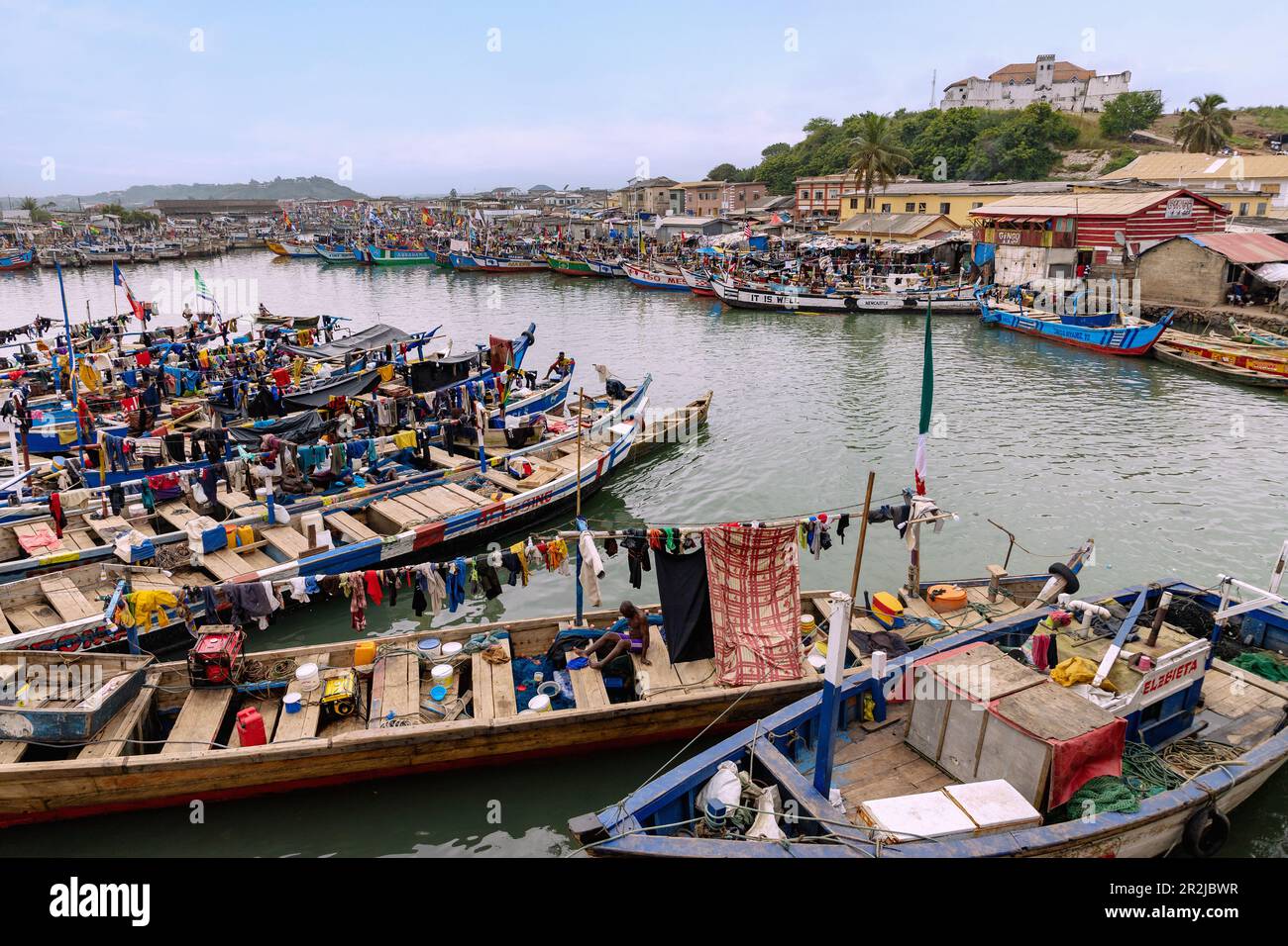 Fishing port in Elmina looking towards the Fortress of São Jago da Mina ...