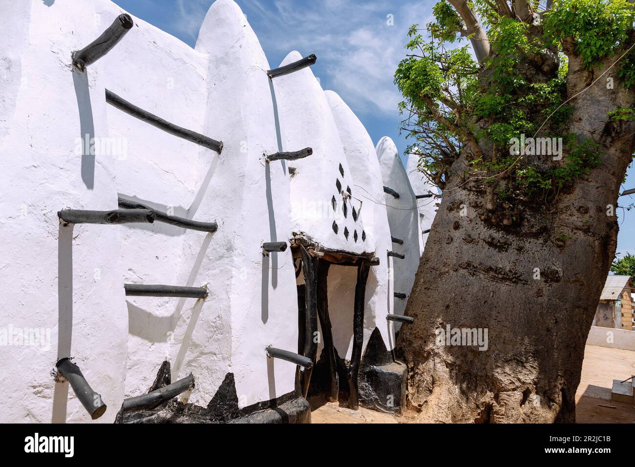 Larabanga Mosque, entrance of women and baobab, in the Savannah region ...