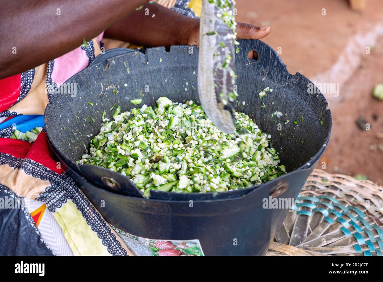 Processing and selling okra at the weekly market in Techiman in the ...