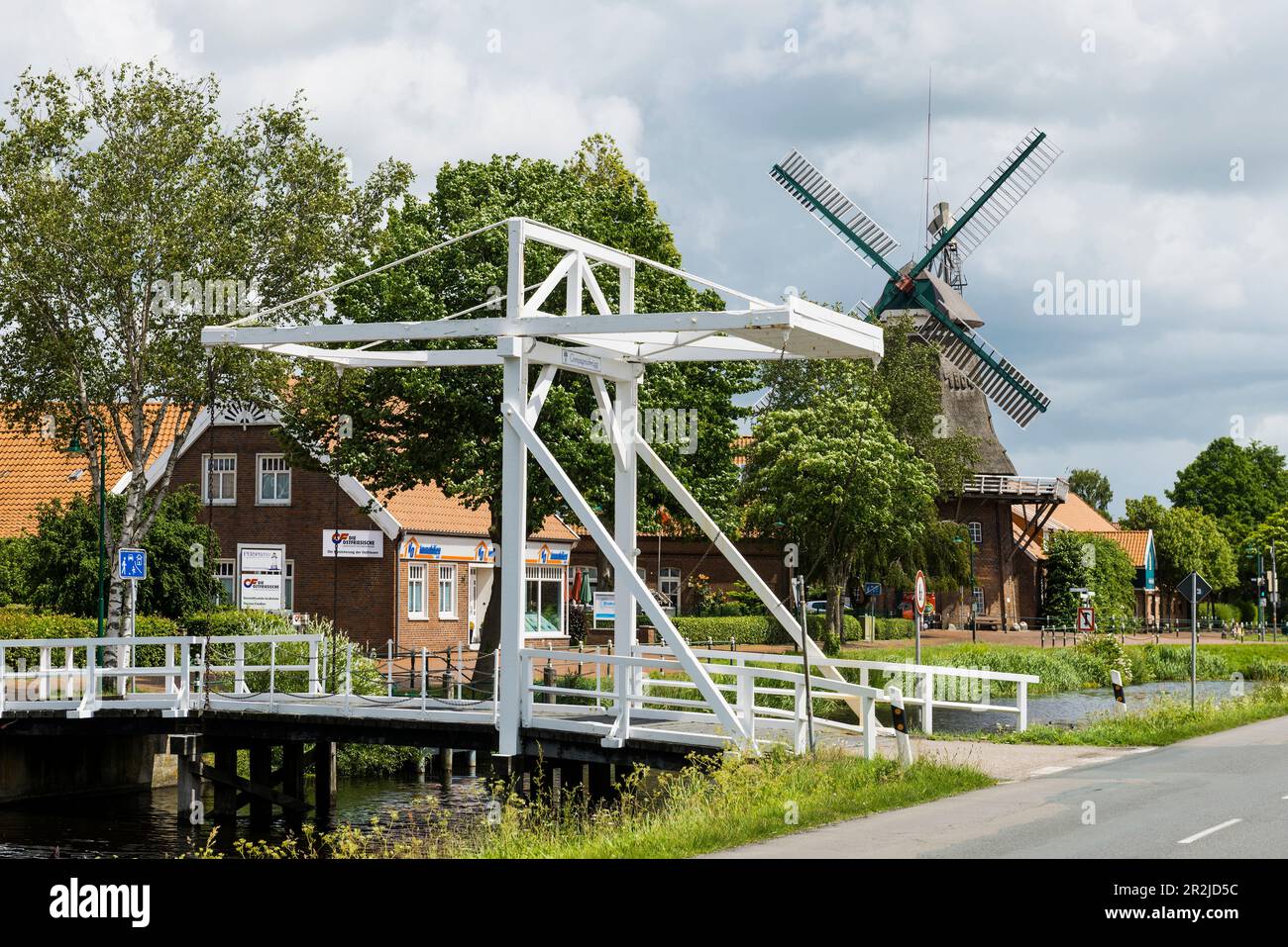 Canal with historic bascule bridge and windmill, Westgrossefehn ...