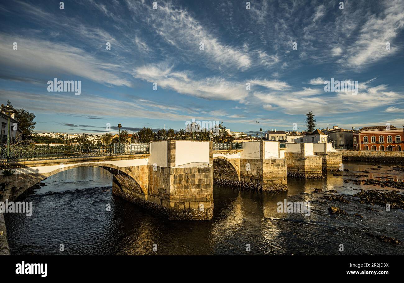 Ponte Romana and the Rio Gilao under a cloudy blue sky, Tavira, Algarve ...