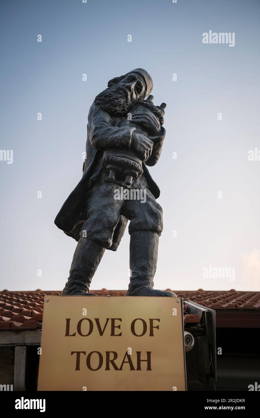 Sculpture of an orthodox Jew hugging a Torah, inscription Love of Torah ...