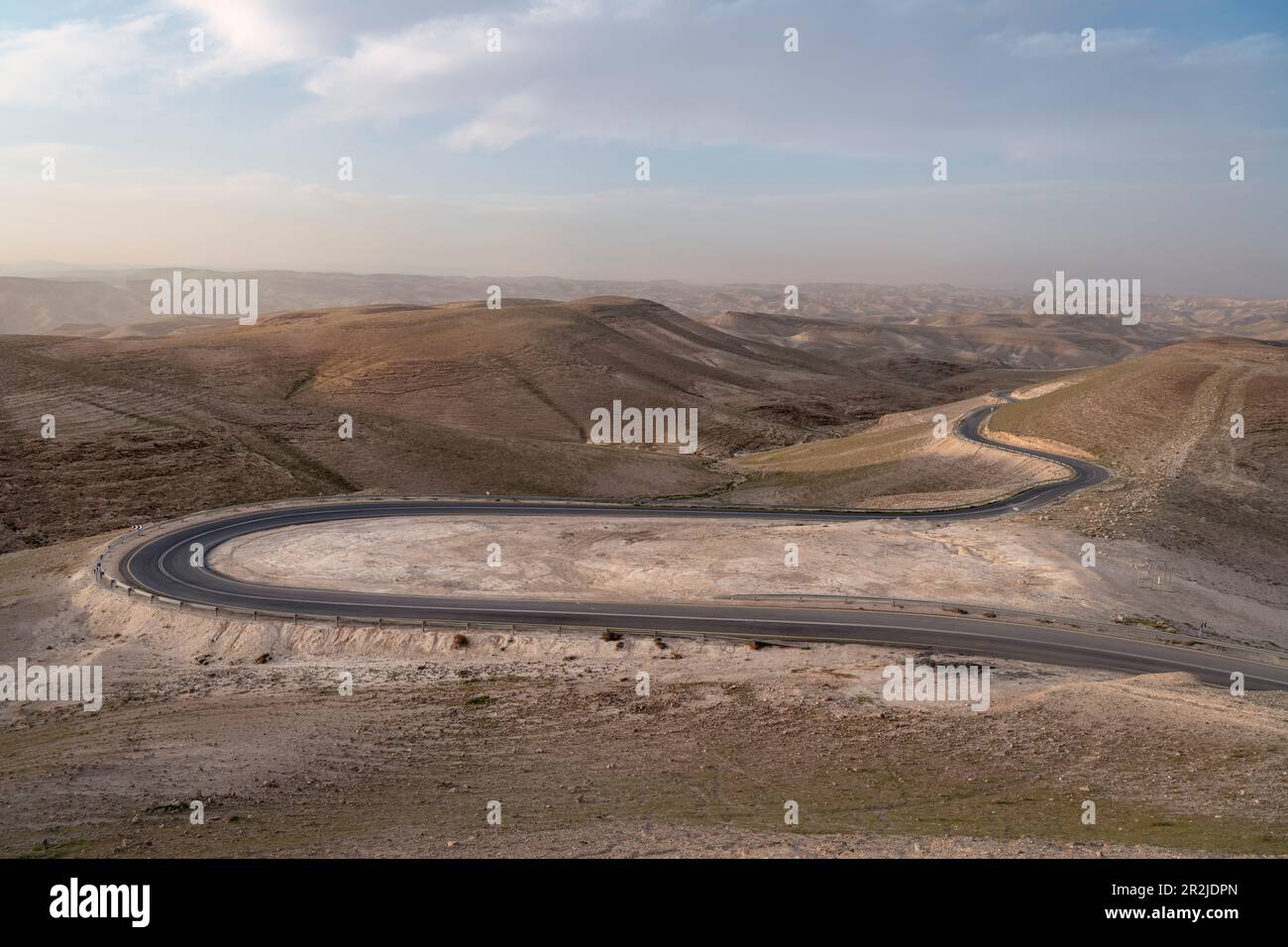 well-developed road leads through barren landscape to the fortress of ...