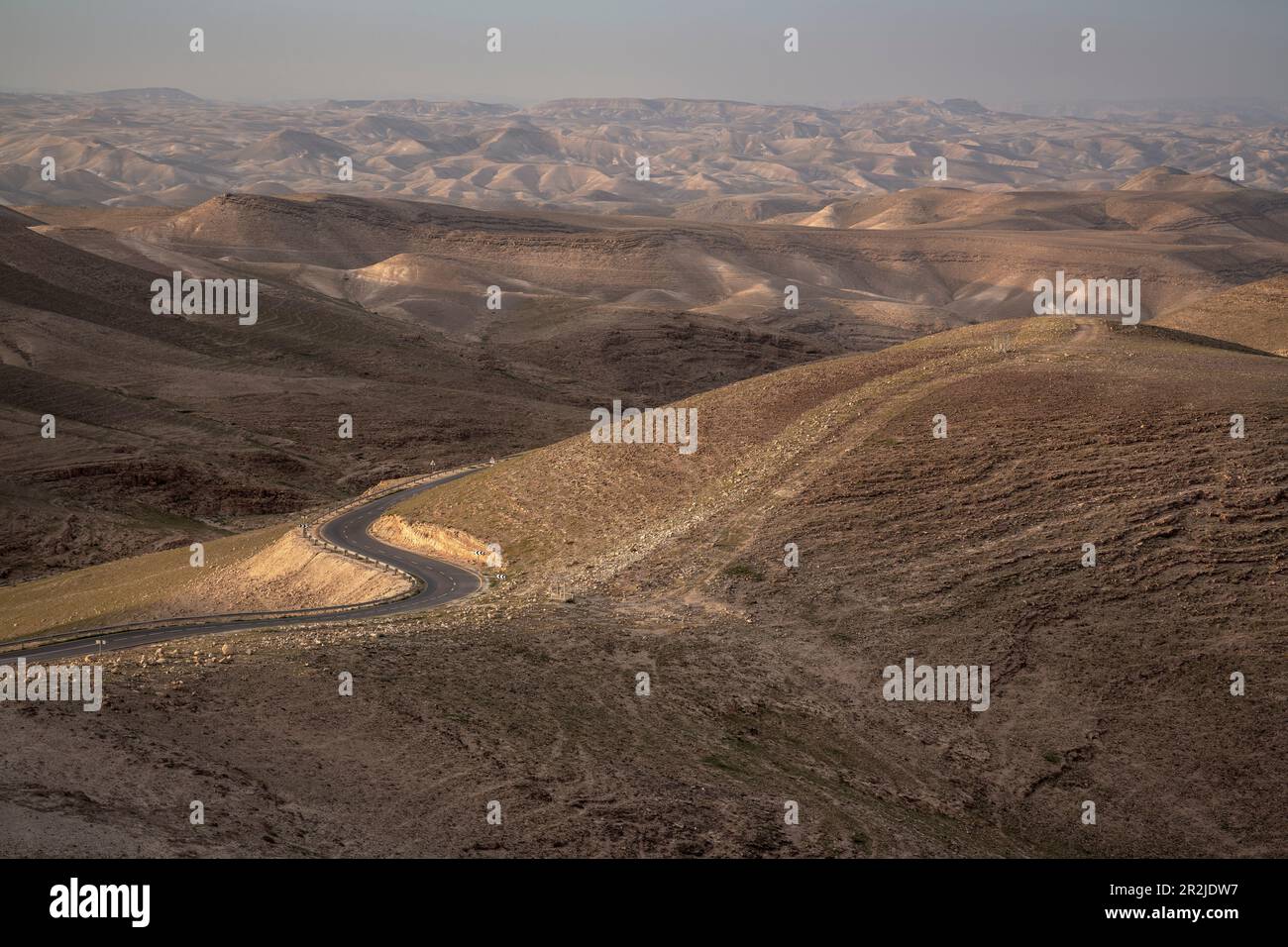 well-developed road leads through barren landscape to the fortress of ...