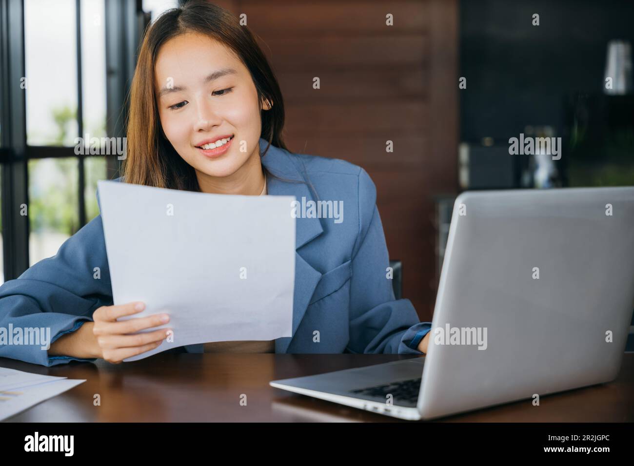young business woman reading report document compare with laptop ...
