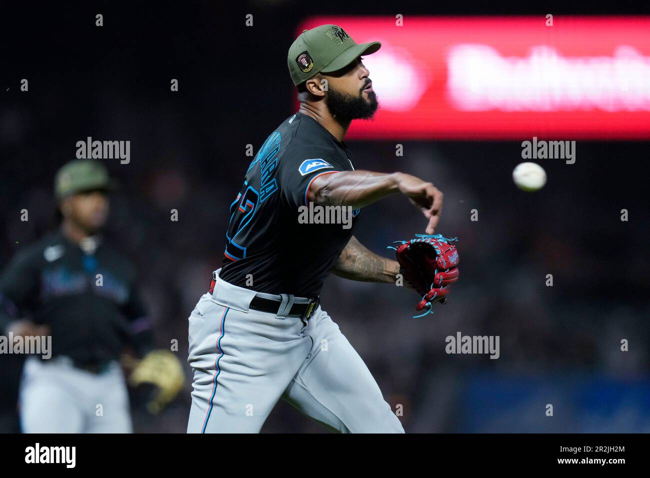 Miami Marlins pitcher Sandy Alcantara throws to first on a ball hit by ...