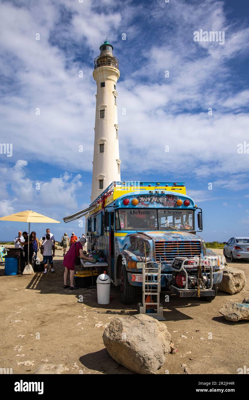 People in front of snack bar in colorful old school bus at California ...