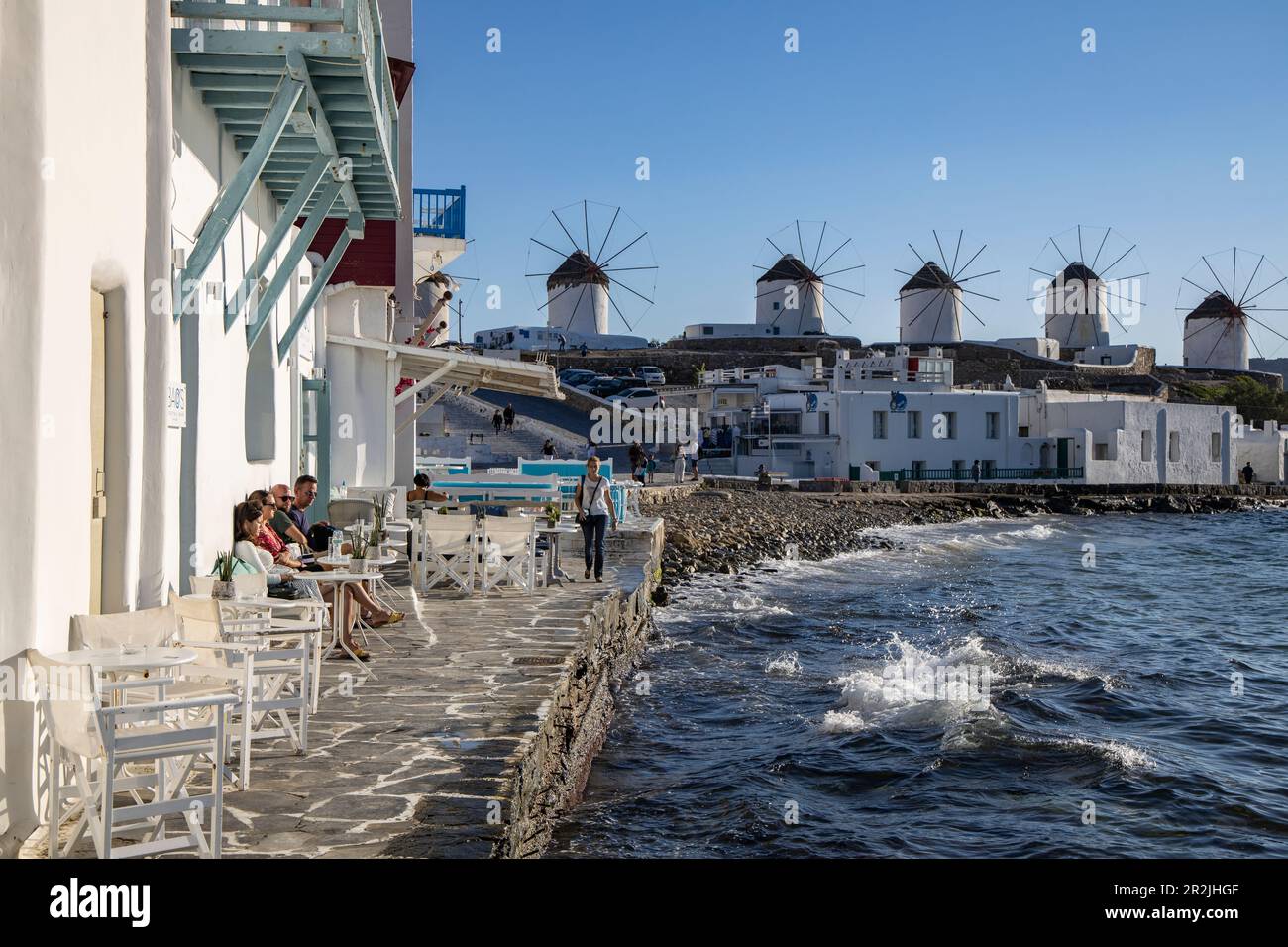 Tables and chairs in a Little Venice restaurant with the famous Mykonos ...