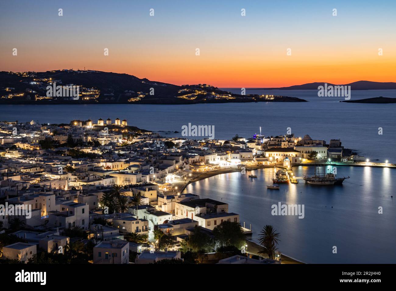 View over the town with the famous Mykonos windmills and port seen from ...