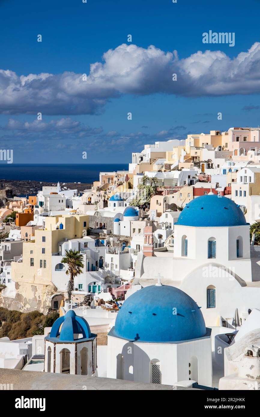 Blue domes of a Greek Orthodox Church and cliff-top houses, Oia ...