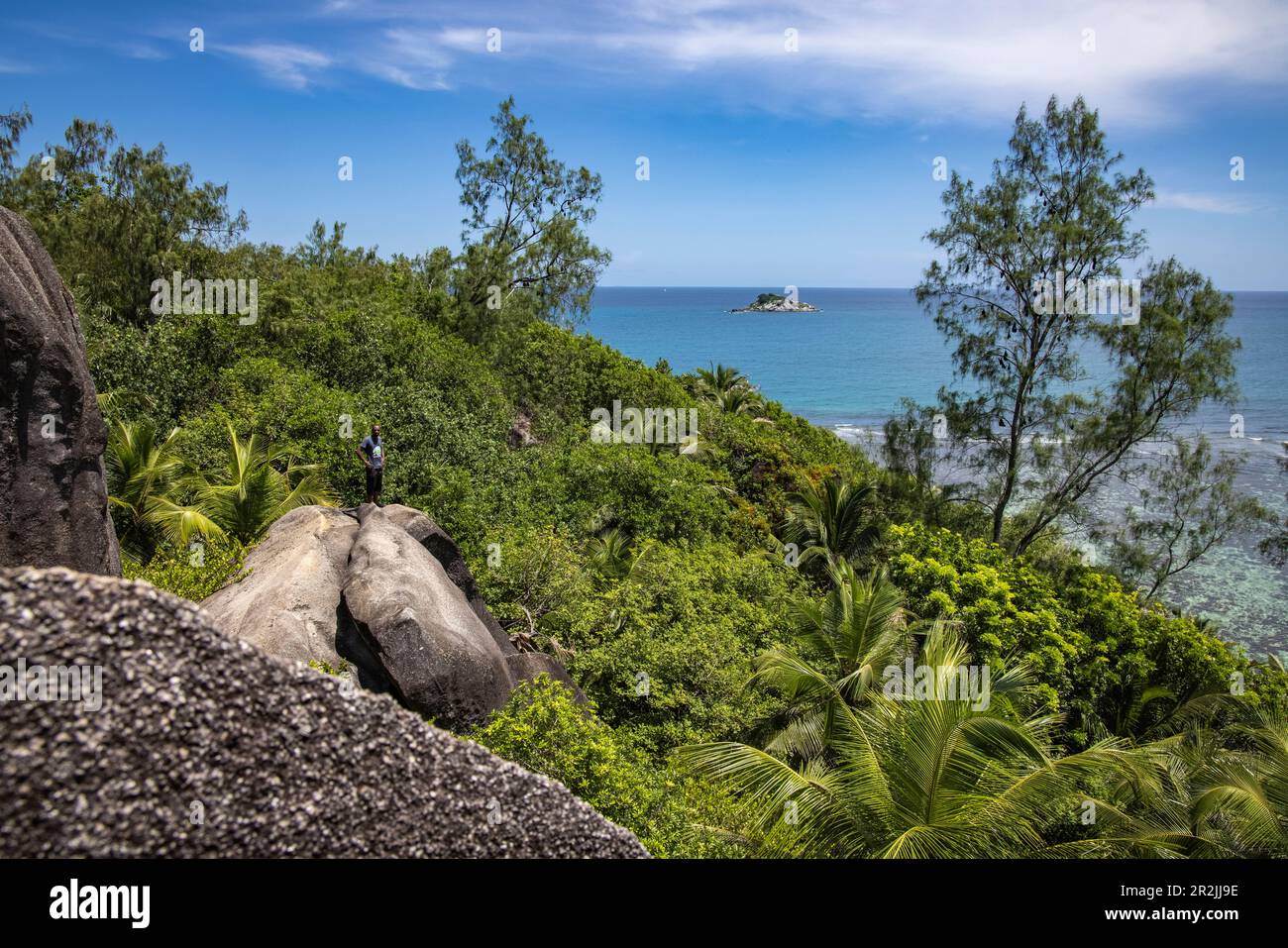 Ranger guide standing on granite rock, Moyenne Island, St Anne Marine ...