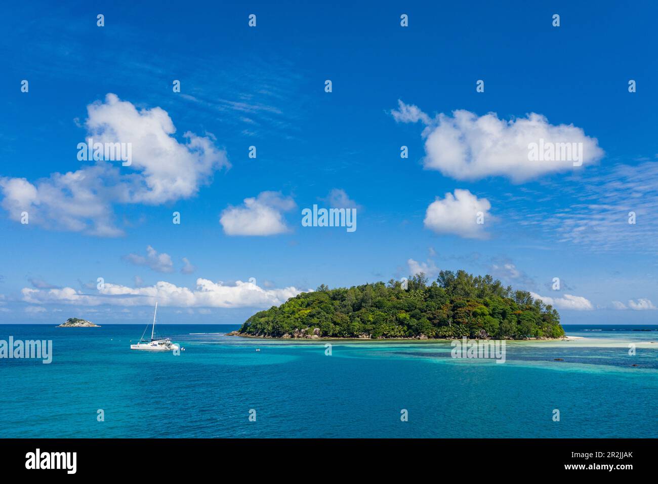 Aerial view of a sailing catamaran off island, St Anne Marine National ...