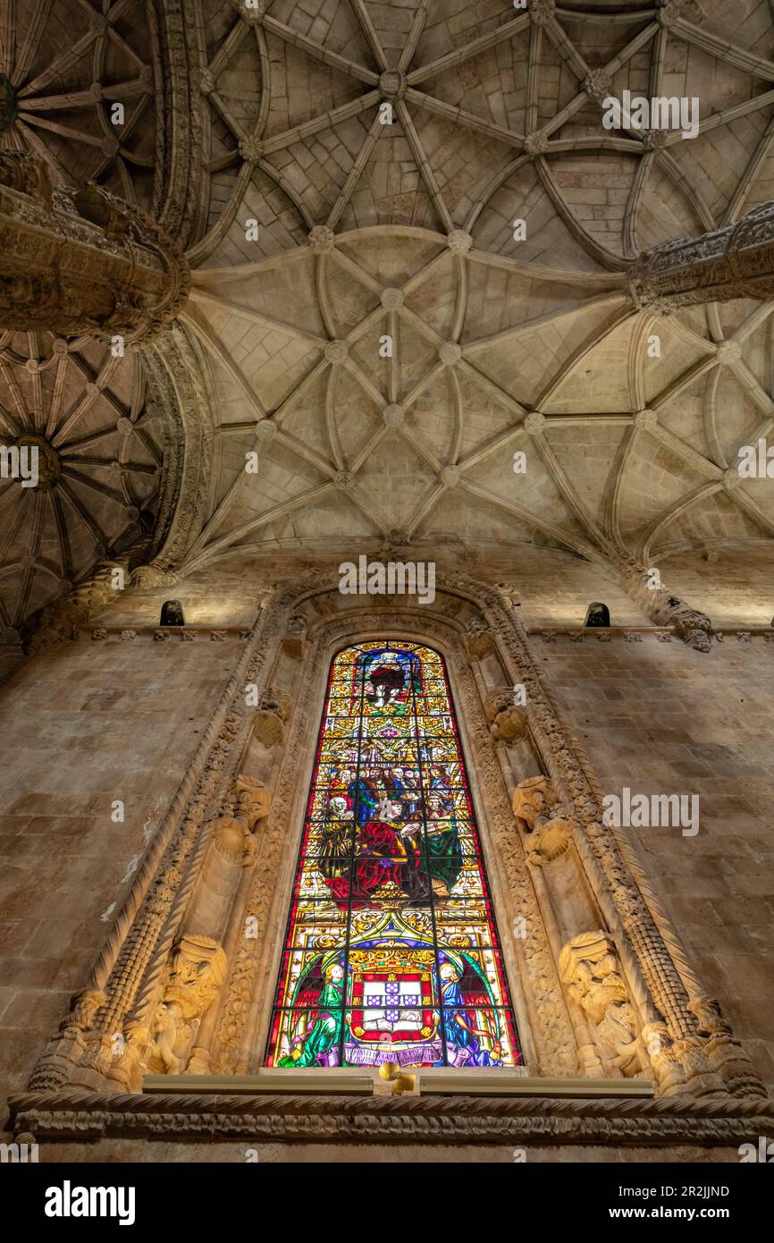 Looking up at the vaulted ceiling and stained glass windows of the ...
