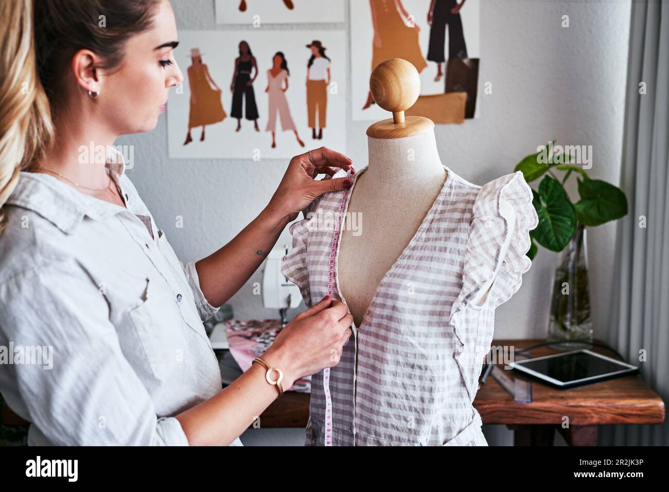 Fashion, woman and designer with mannequin, measuring tape and and work ...