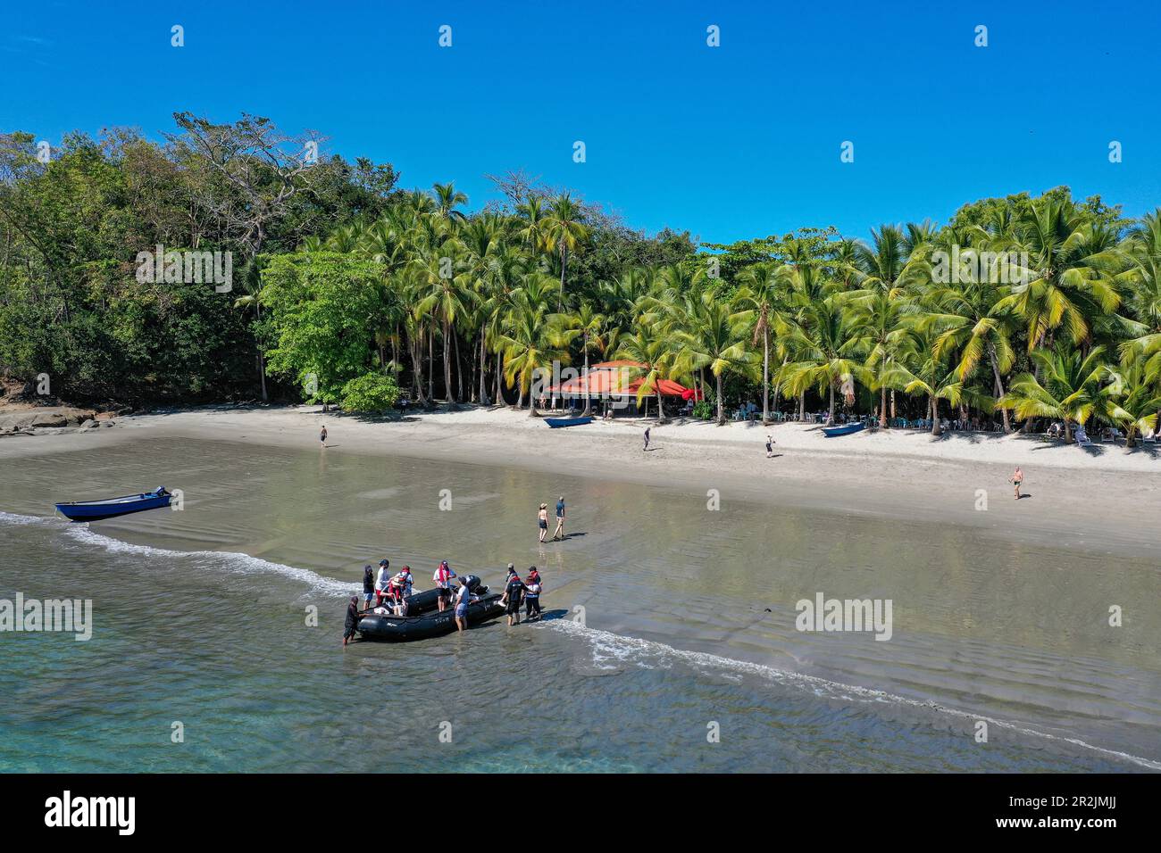 Aerial view of Zodiac inflatable boat landing on beach for passengers ...