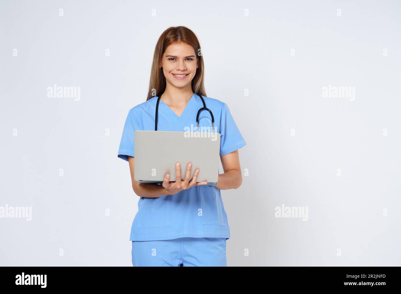 Portrait of smiling young woman doctor with stethoscope holding in ...