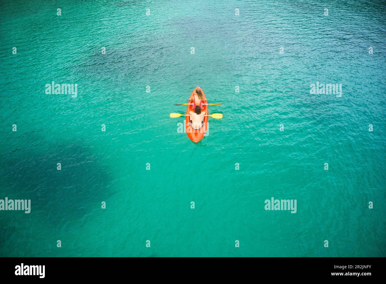 Top view, adventure and couple with ocean, canoeing and summer vacation with getaway, break and ...