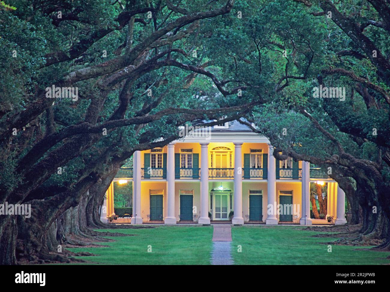 View through an oak alley at a house at dusk, Oak Alley Plantation ...