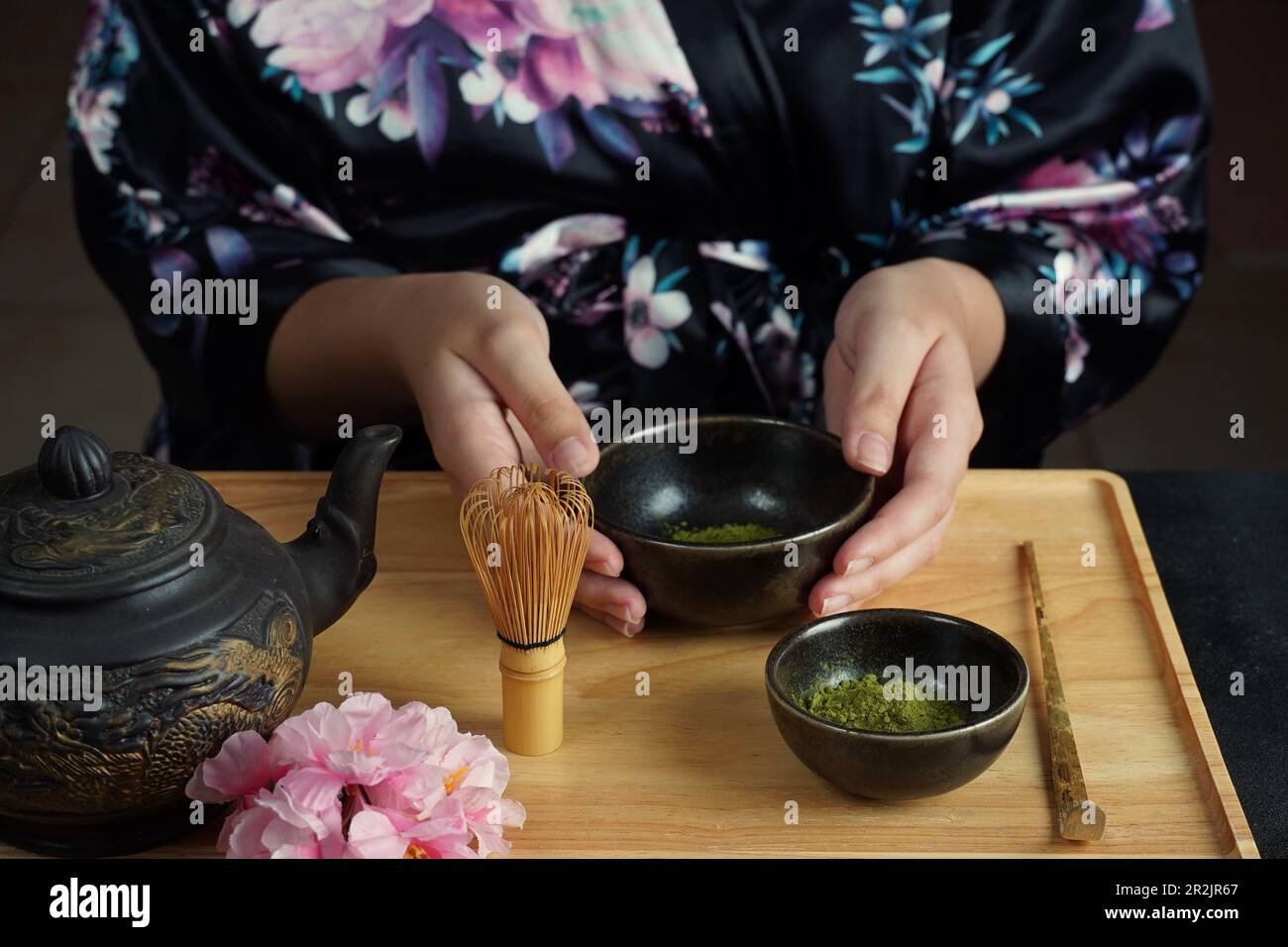 Woman tea master in kimono performs tea ceremony. Matcha green tea ...