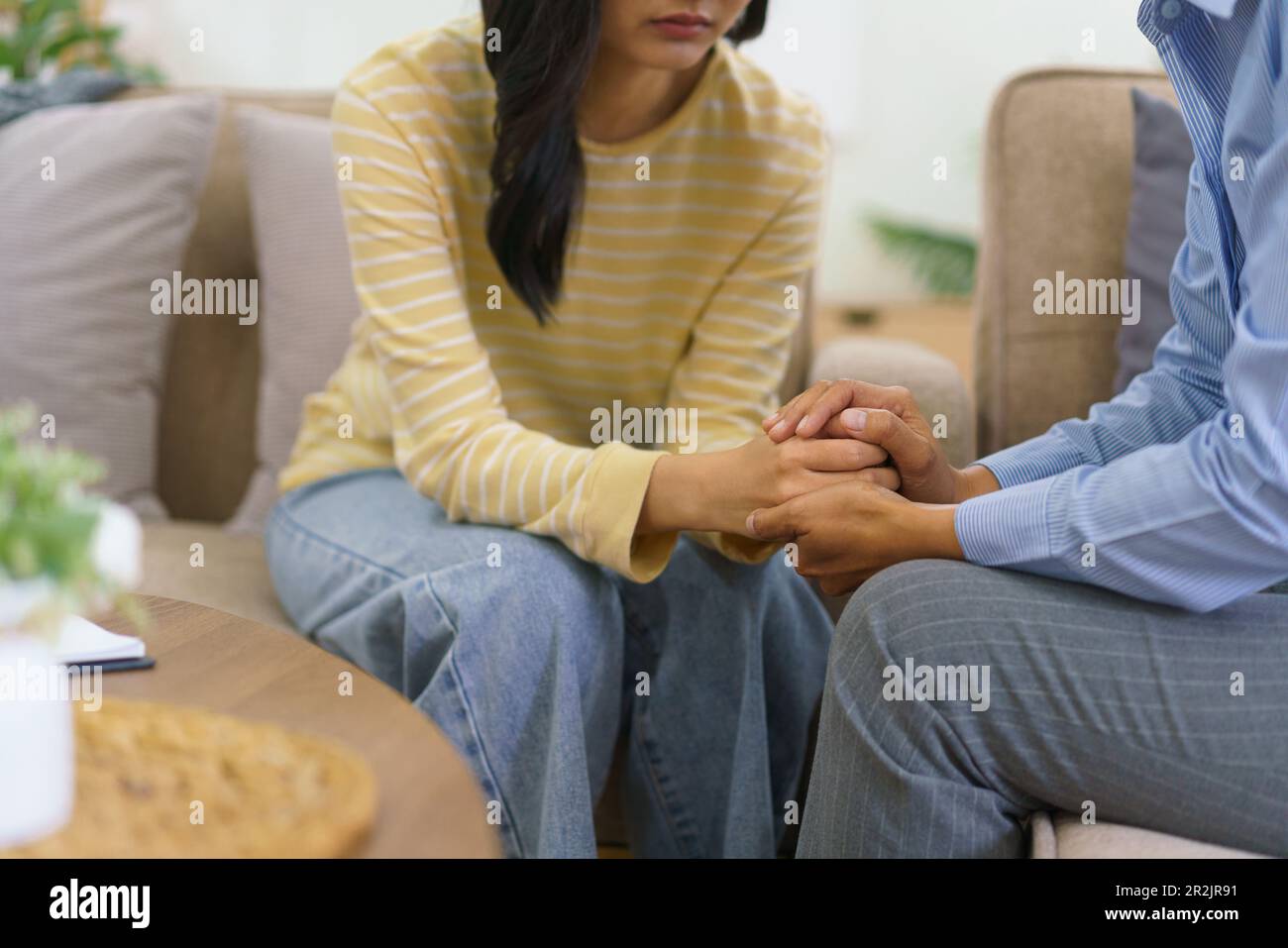Female psychologist touching hands to comforting and encourage stress ...