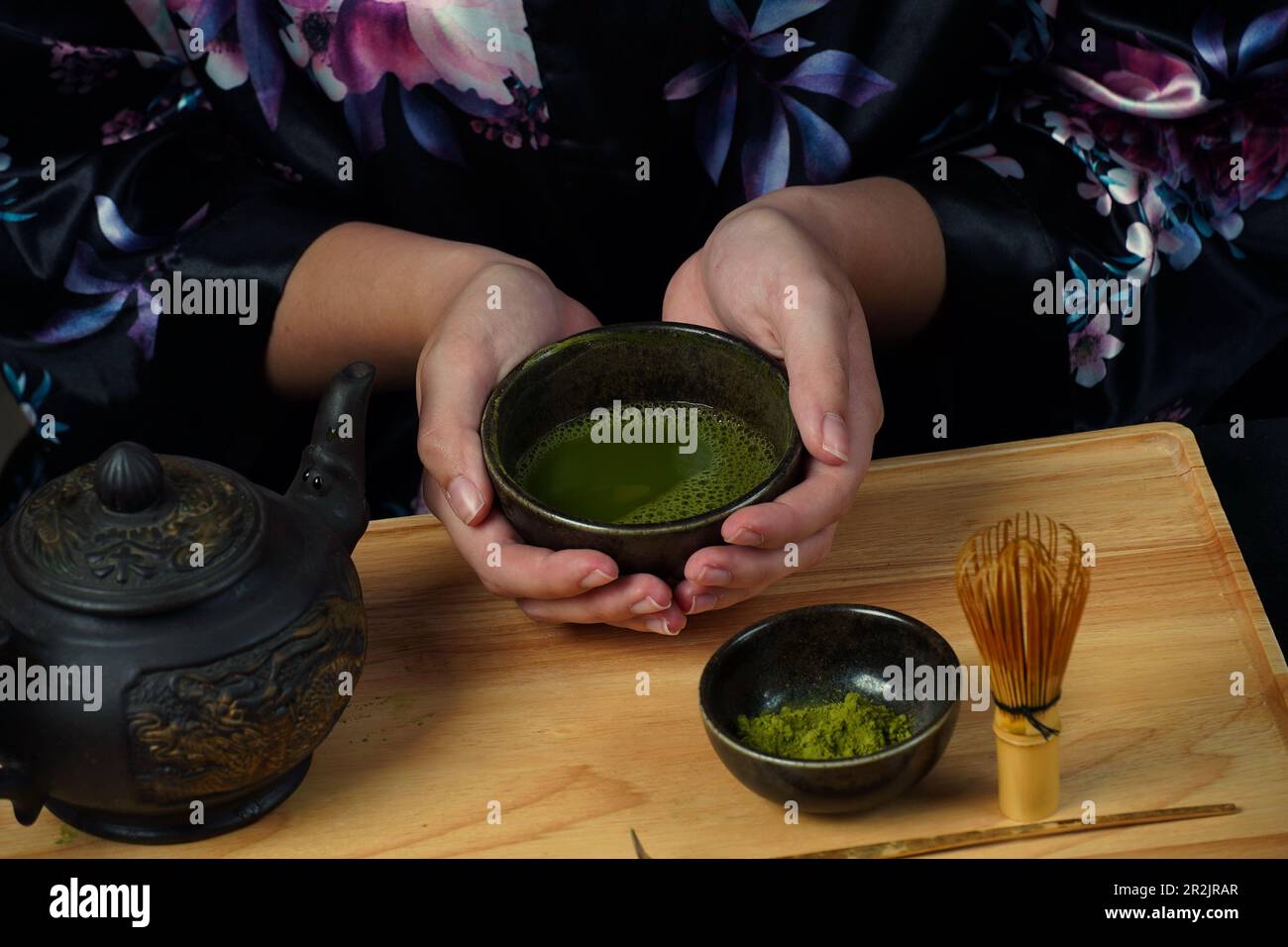Woman tea master in kimono performs tea ceremony. Matcha green tea ...