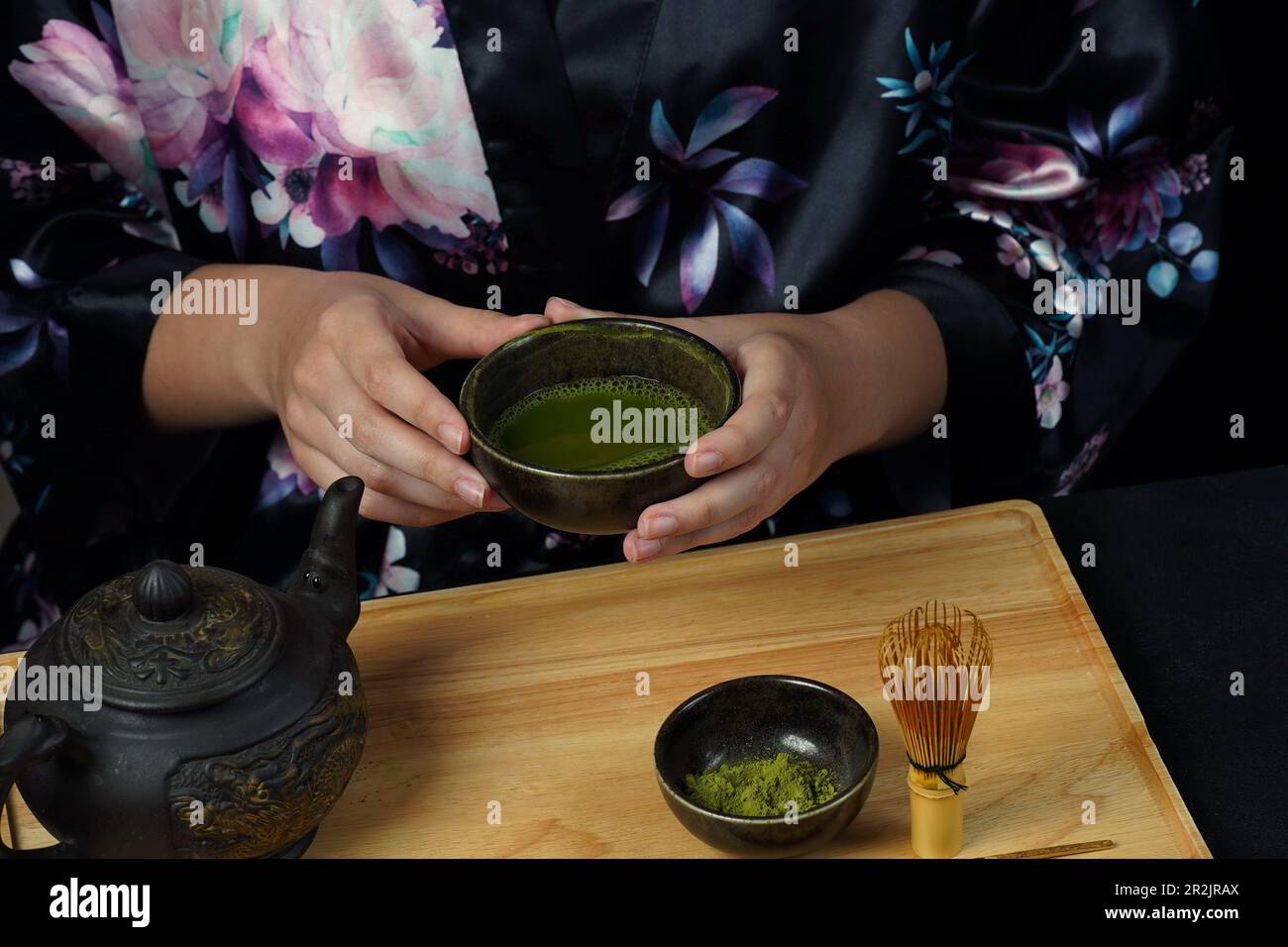Woman tea master in kimono performs tea ceremony. Matcha green tea ...