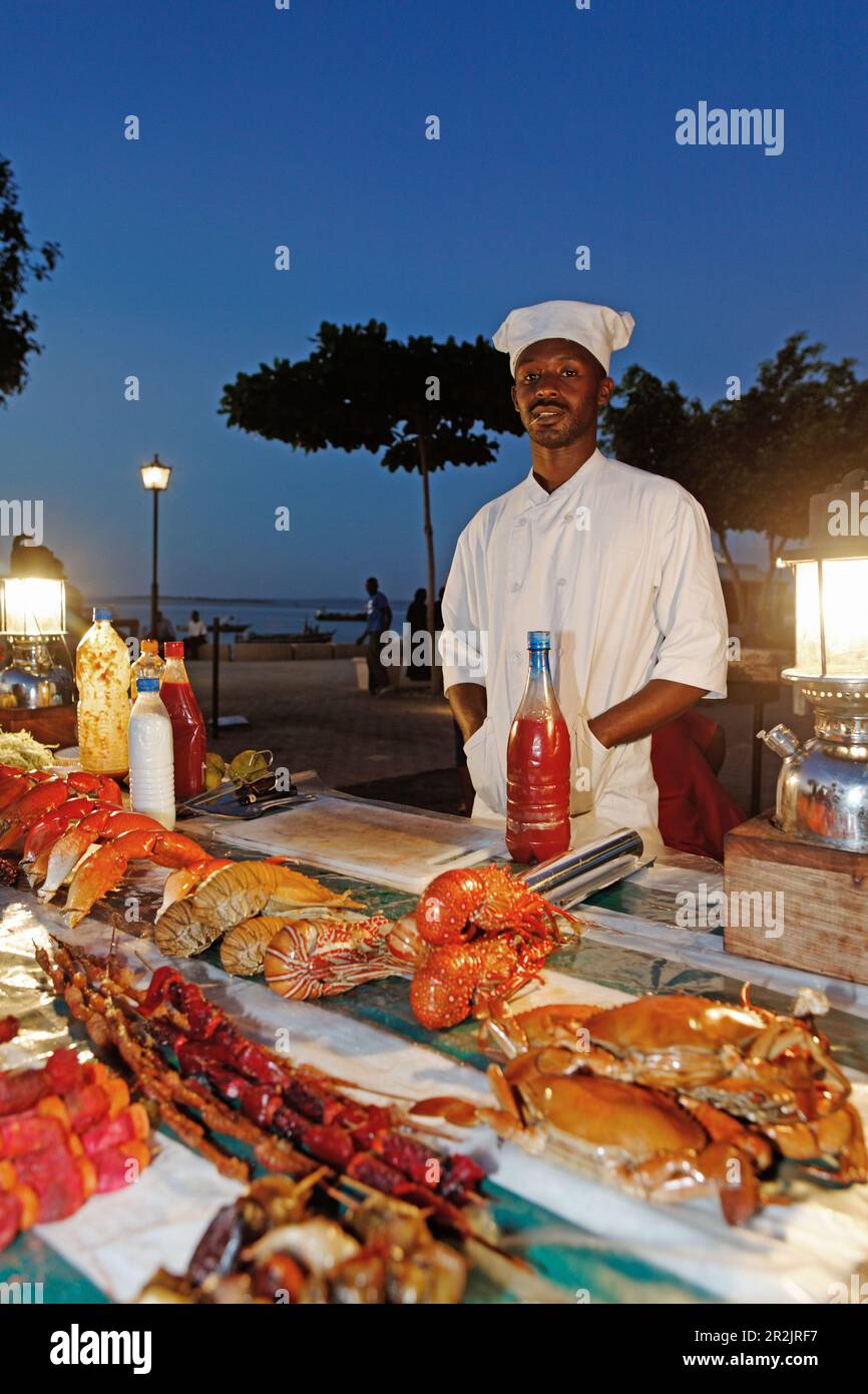 Monger at a stand, night market at Forodhani Gardens, Stonetown ...