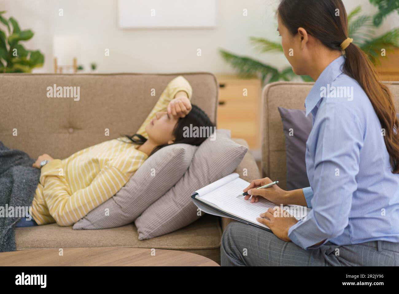 Female patients lying on couch and having session therapy from ...