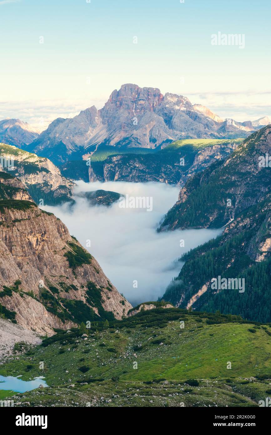 Mountain canyon filled with clouds at sunrise in Dolomites, Alps, Italy ...