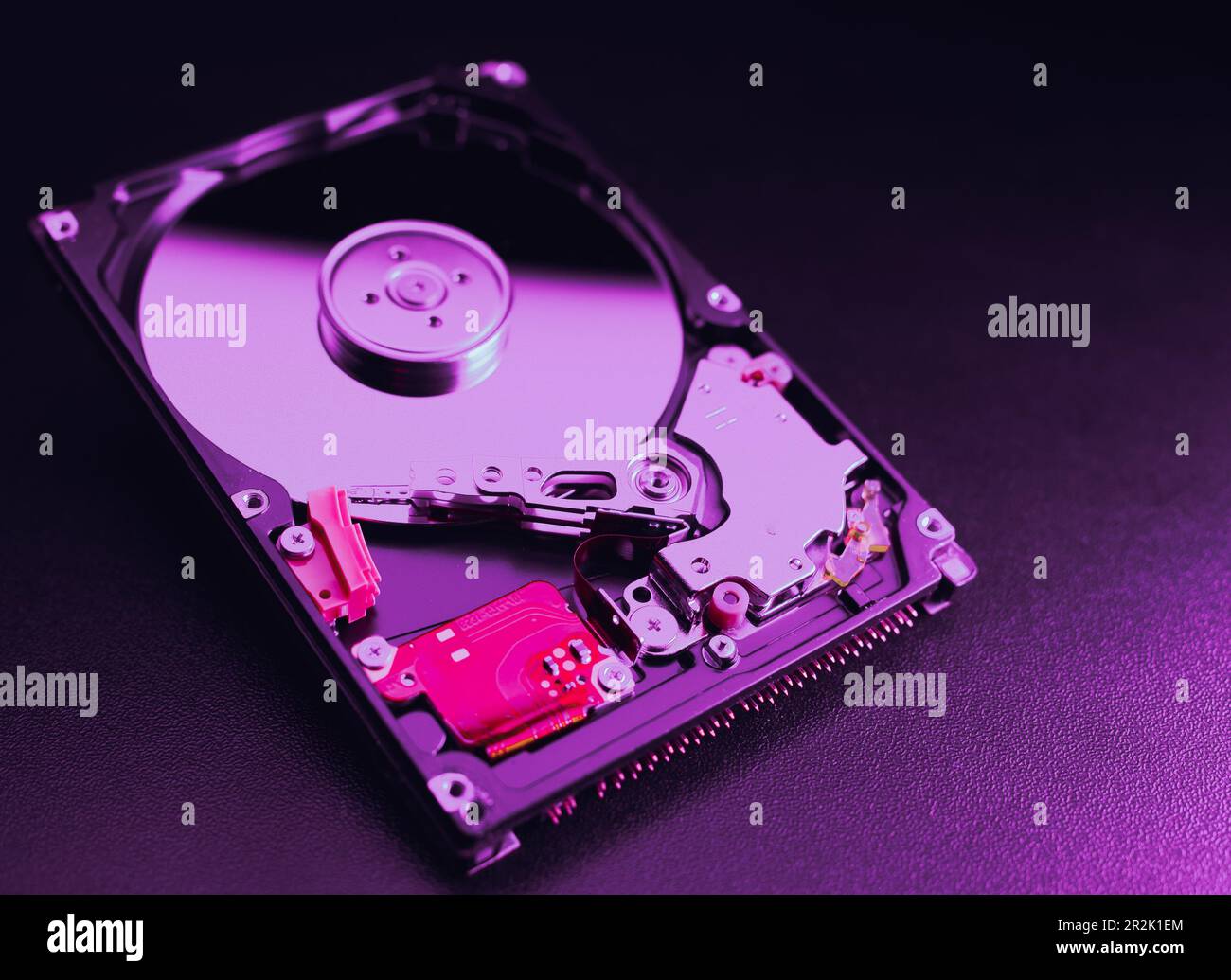An open hard disk disassembled HDD of a computer or laptop lies on a ...