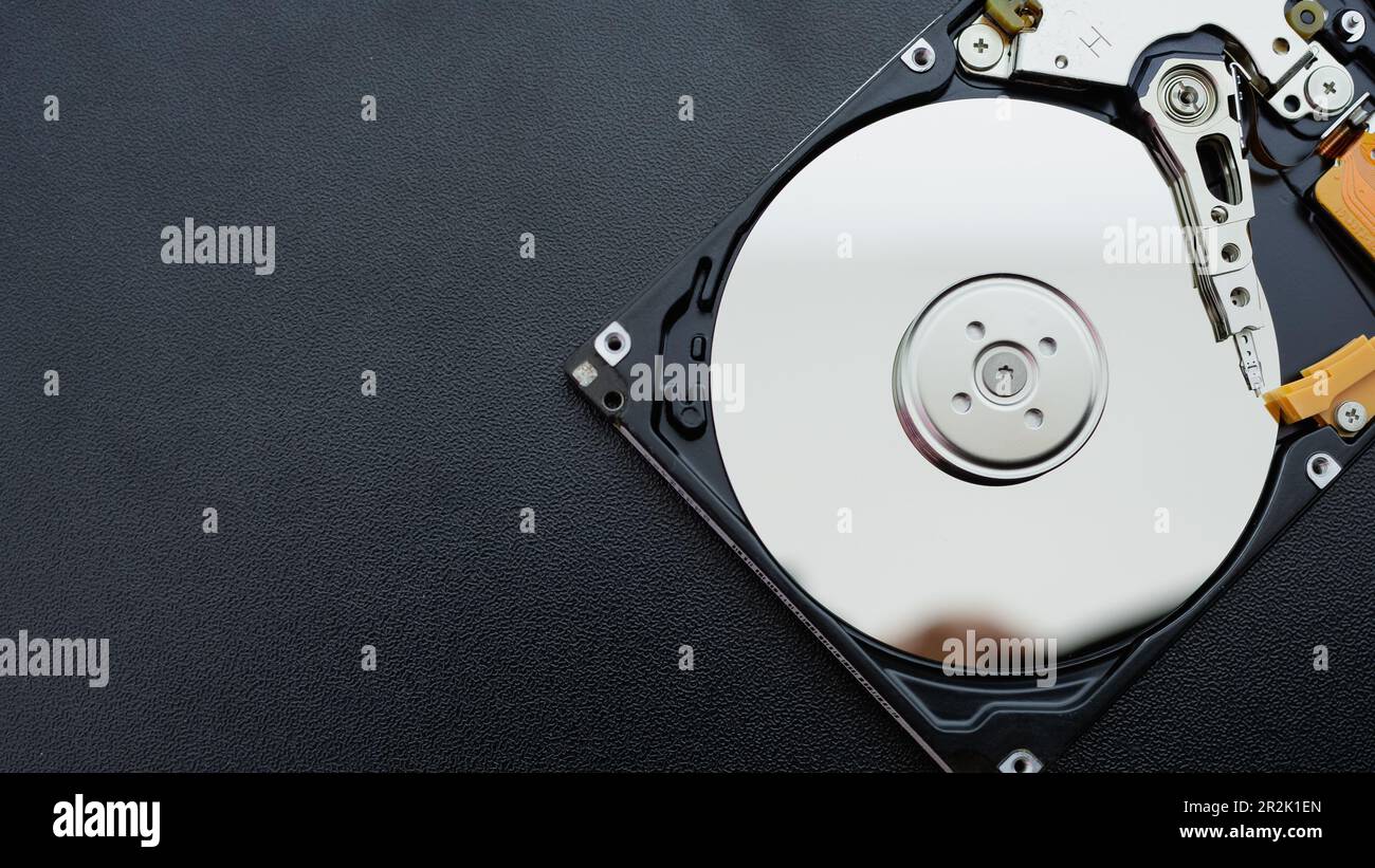 Disassembled open hard disk drive HDD of computer or laptop lies on ...