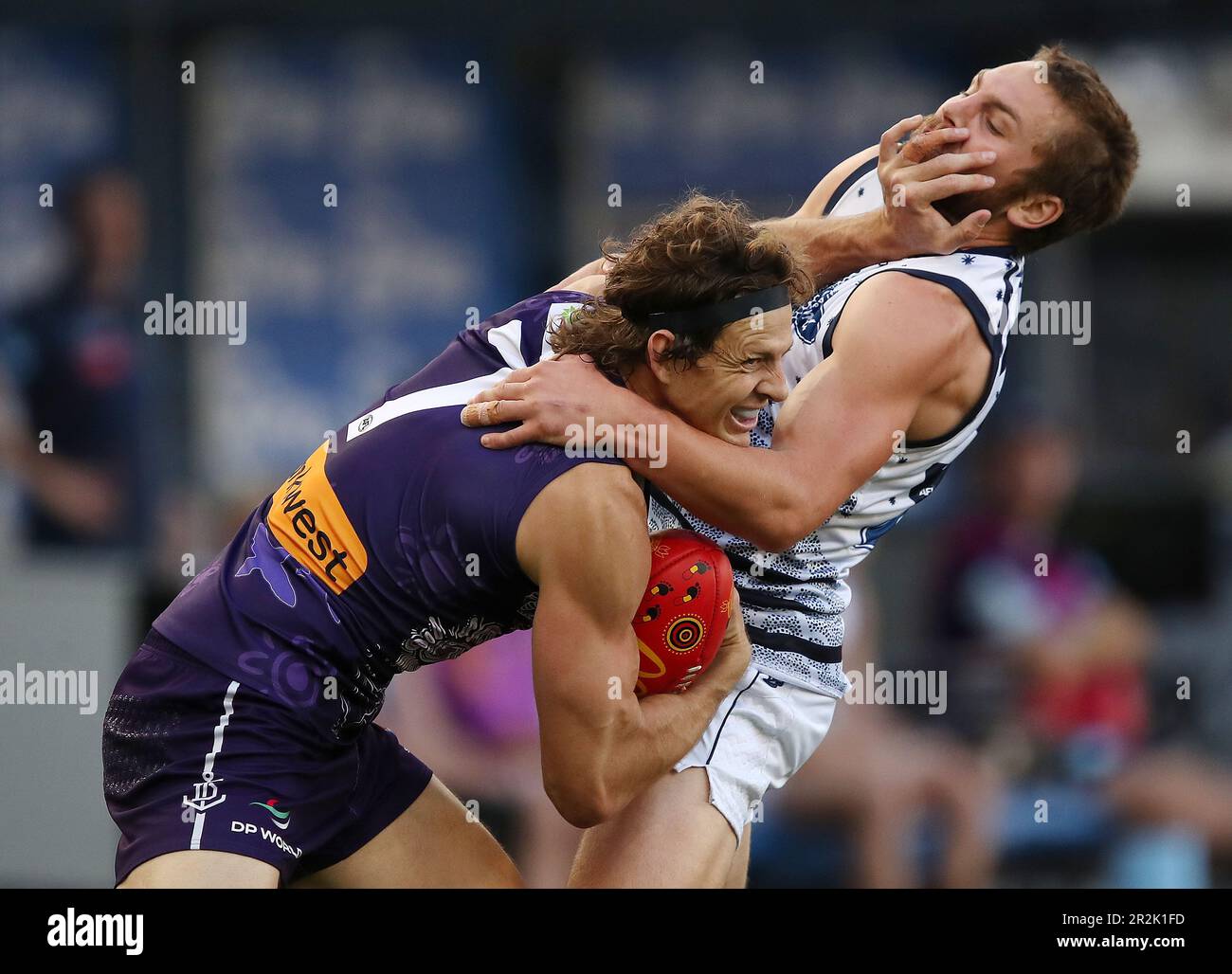 Nat Fyfe of the Dockers hands off Tom Atkins of the Cats during the AFL ...