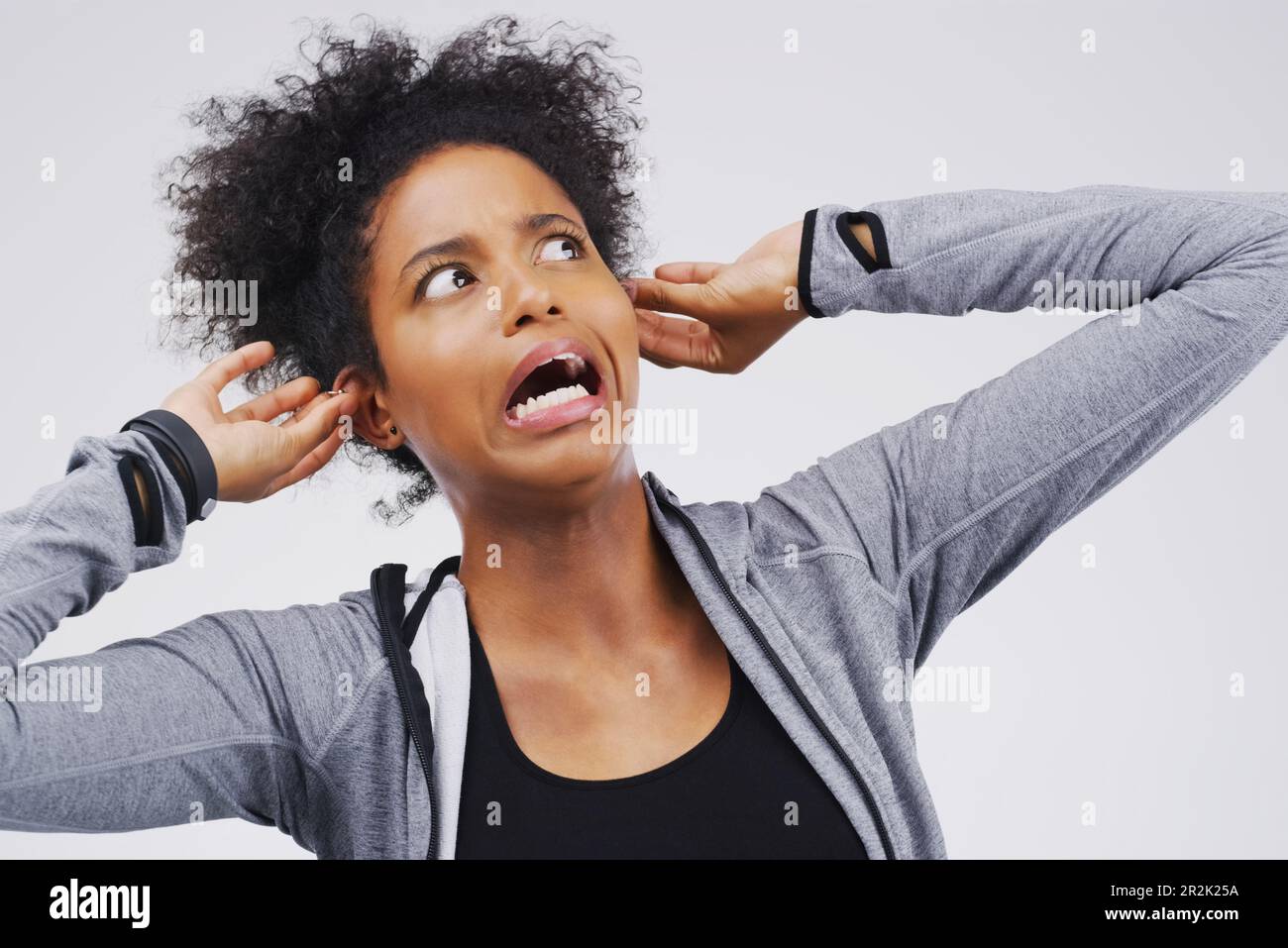 Surprise, funny face and ears with an african woman in studio on a gray ...