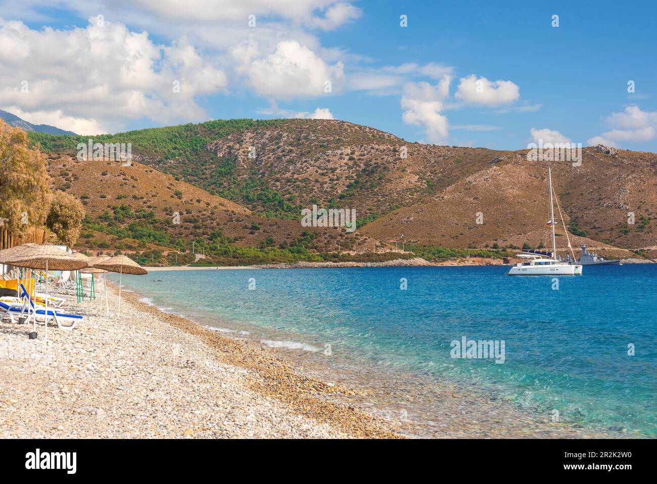 Turkey summer resort with pebble beach and yacht. Palamutbuku beach in ...
