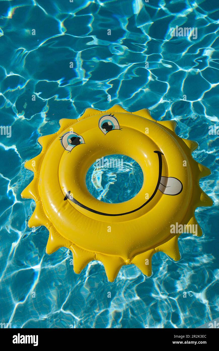 An buoy shaped line a sun, floats in a swimming pool, south of france ...