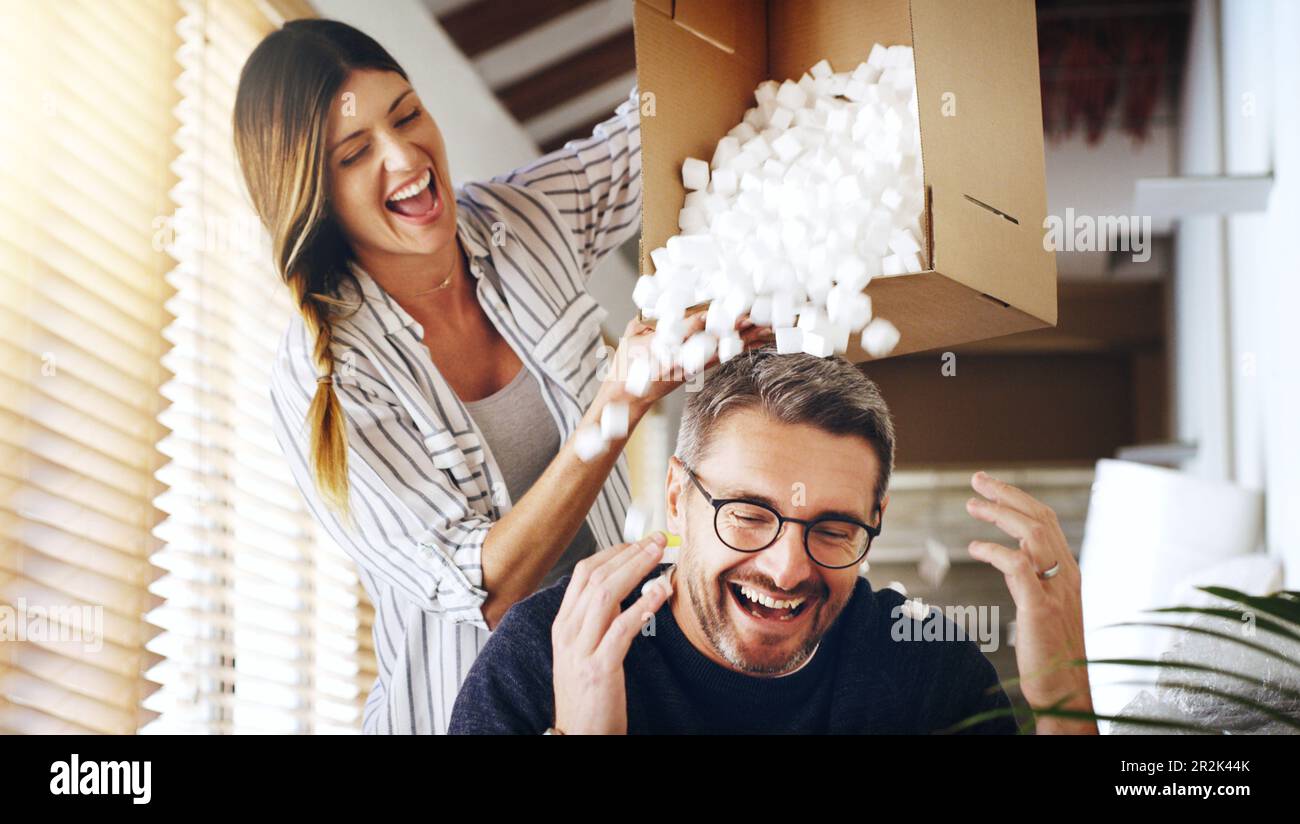 Moving house, real estate and box with a crazy married couple having ...