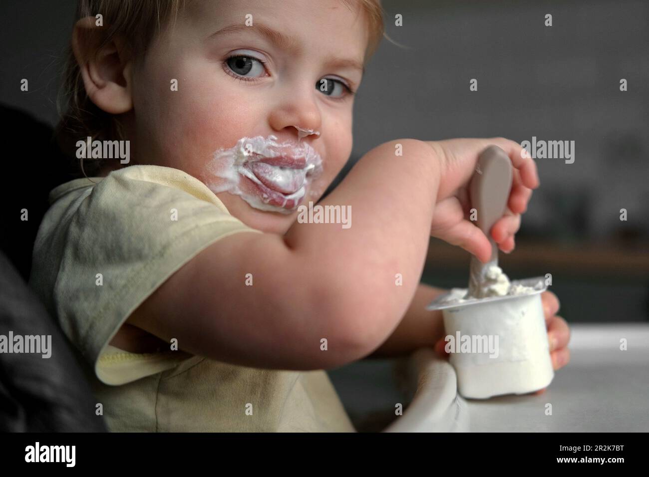 Young Kid Eating Blend Mashed Feed Sitting in High Chair. Baby Weaning ...