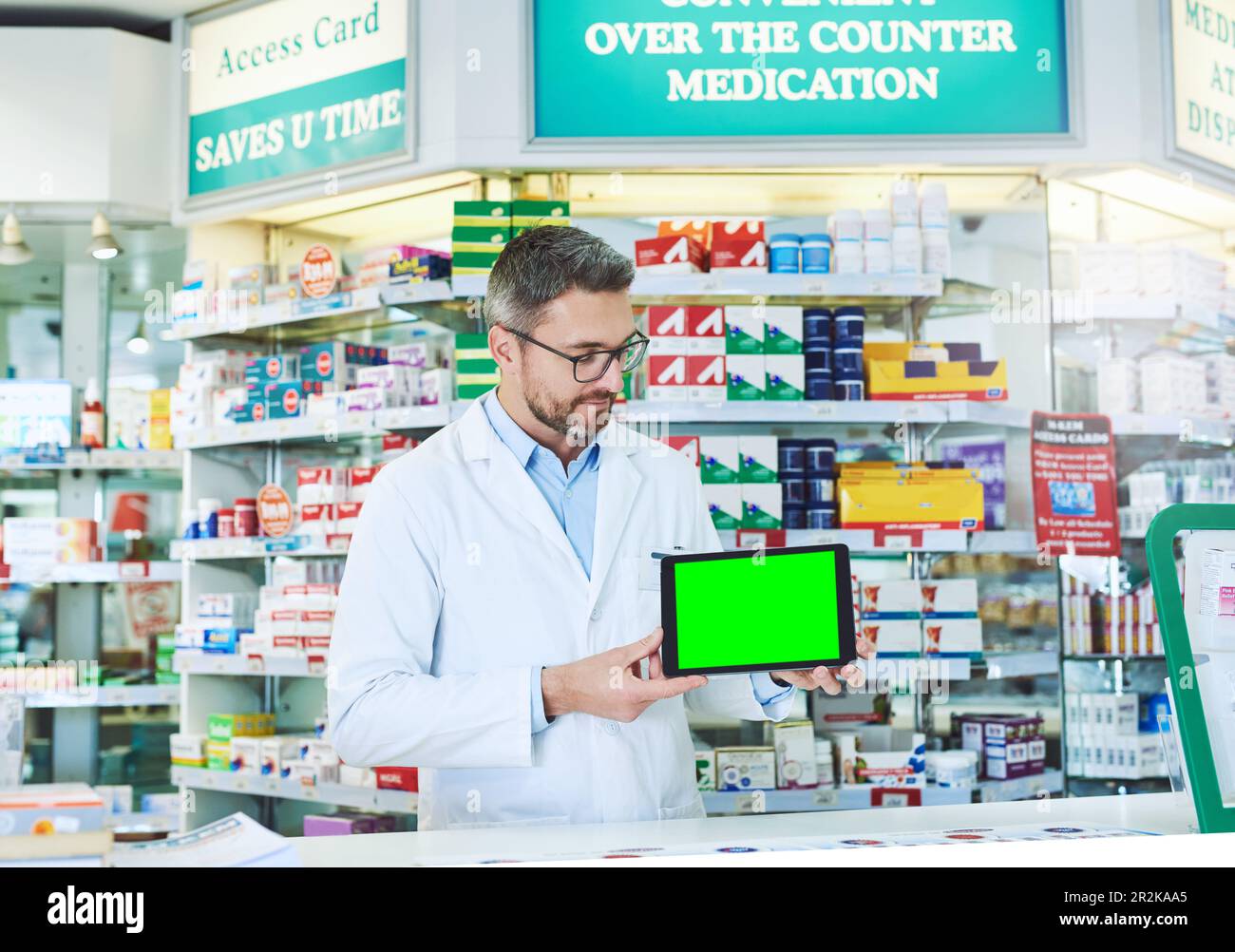 Man, pharmacist and tablet with green screen with health, store and ...