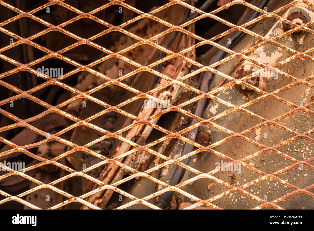 Rusty rhombic sheet metal grille of an old mining truck, useful as a ...