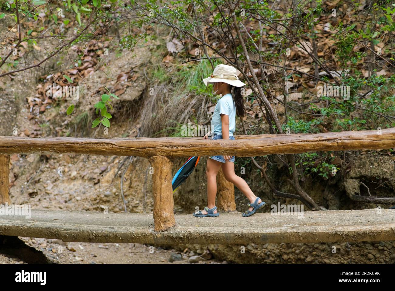 Cute little girl exploring rocks and studying various natural materials ...