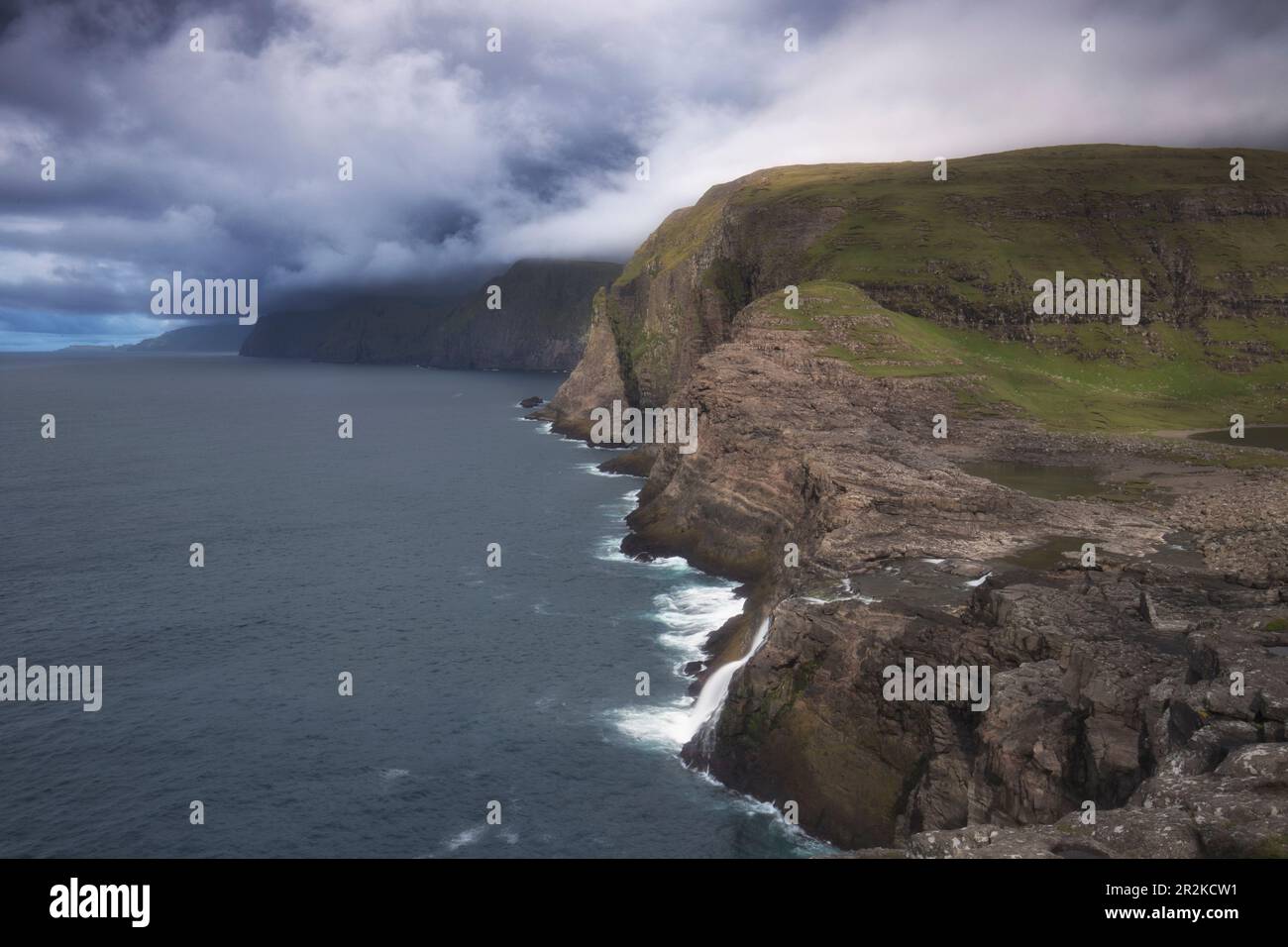 Cliffs of Vagar, Faeroes with Bosdalafossur. Leitisvatn waterfall in ...