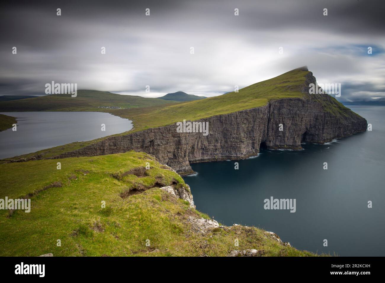 View of cliffs and lake Leitisvatn, Vagar, Faeroerian Islands. Floating ...