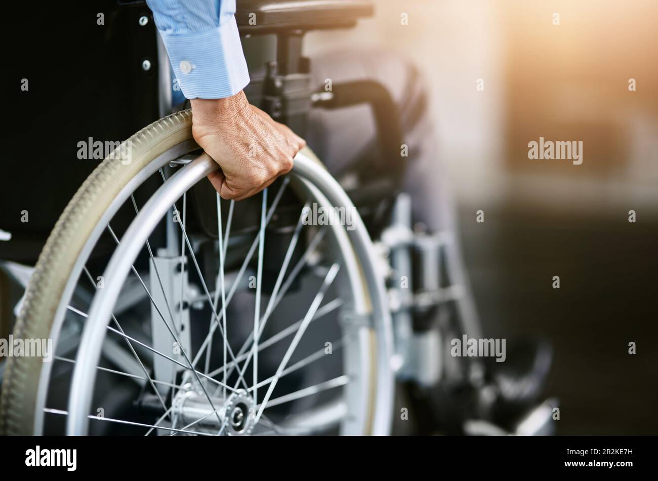 Wheelchair, care and man hand holding wheel in a hospital for ...