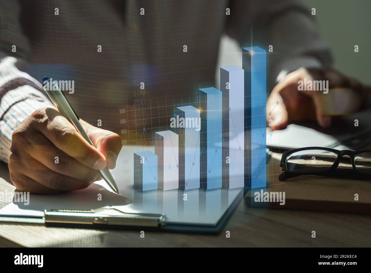 A businessman draws a growth graph showing the success of business ...