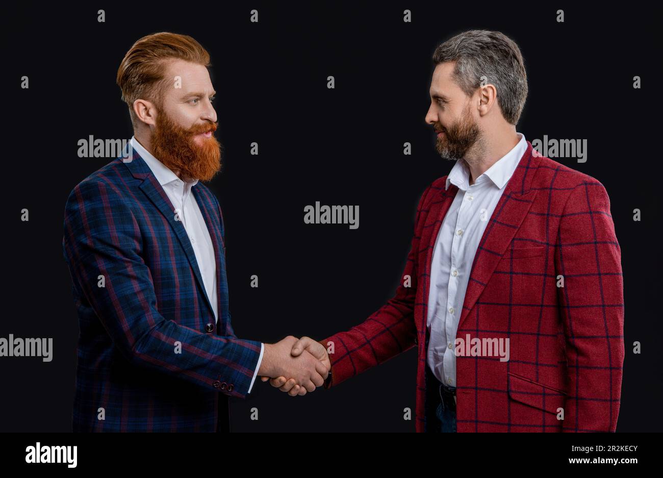 smiling men deal with handshake isolated on black. men deal with ...