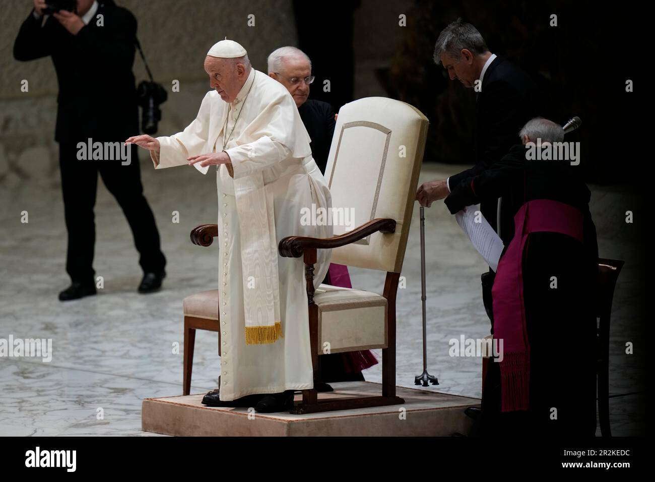 Pope Francis invites people to sit down as he arrives for an audience ...