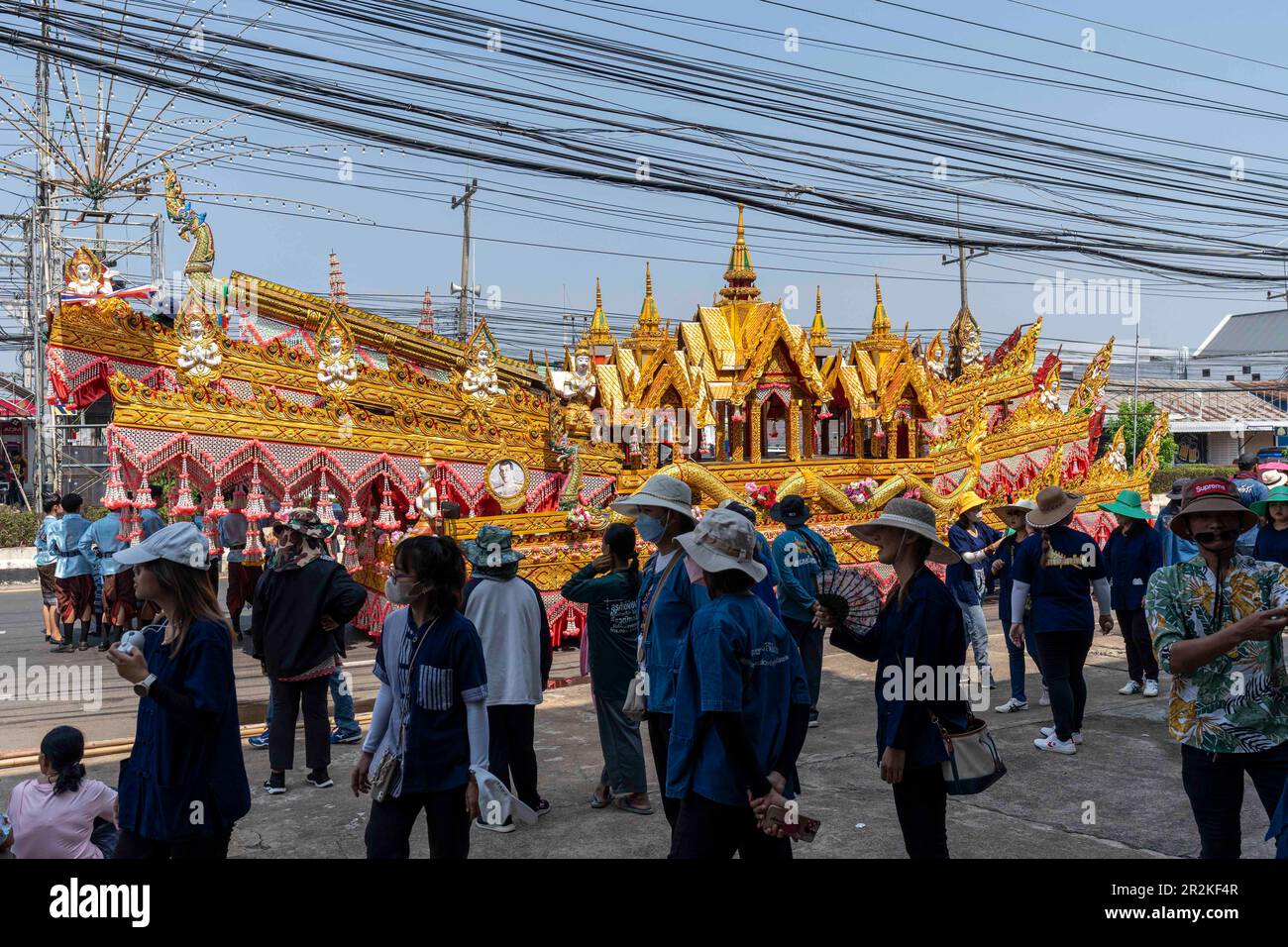 May 20, 2023, Yasothon, Yasothon, Thailand: Festival goers stand in front of an ornately ...