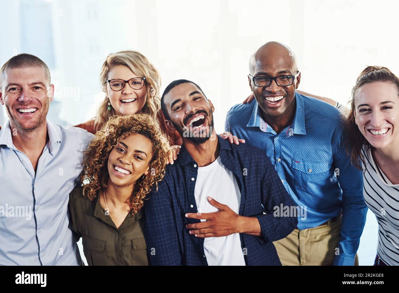 Business people, laugh portrait and hug in a office with a smile from ...