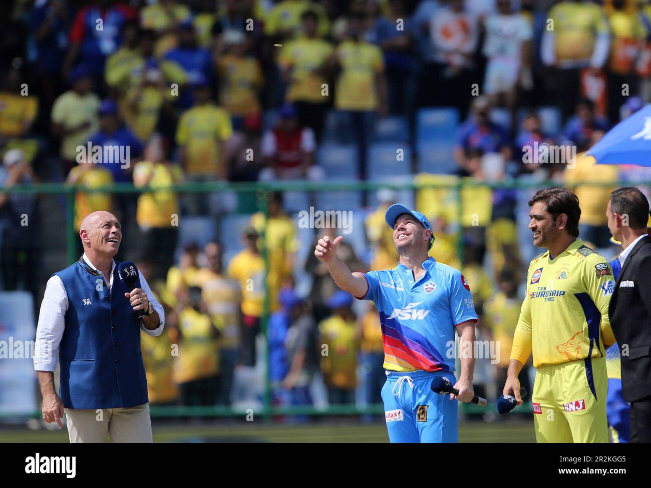 David Warner of Delhi Capitals, left, tosses the coin watched by ...