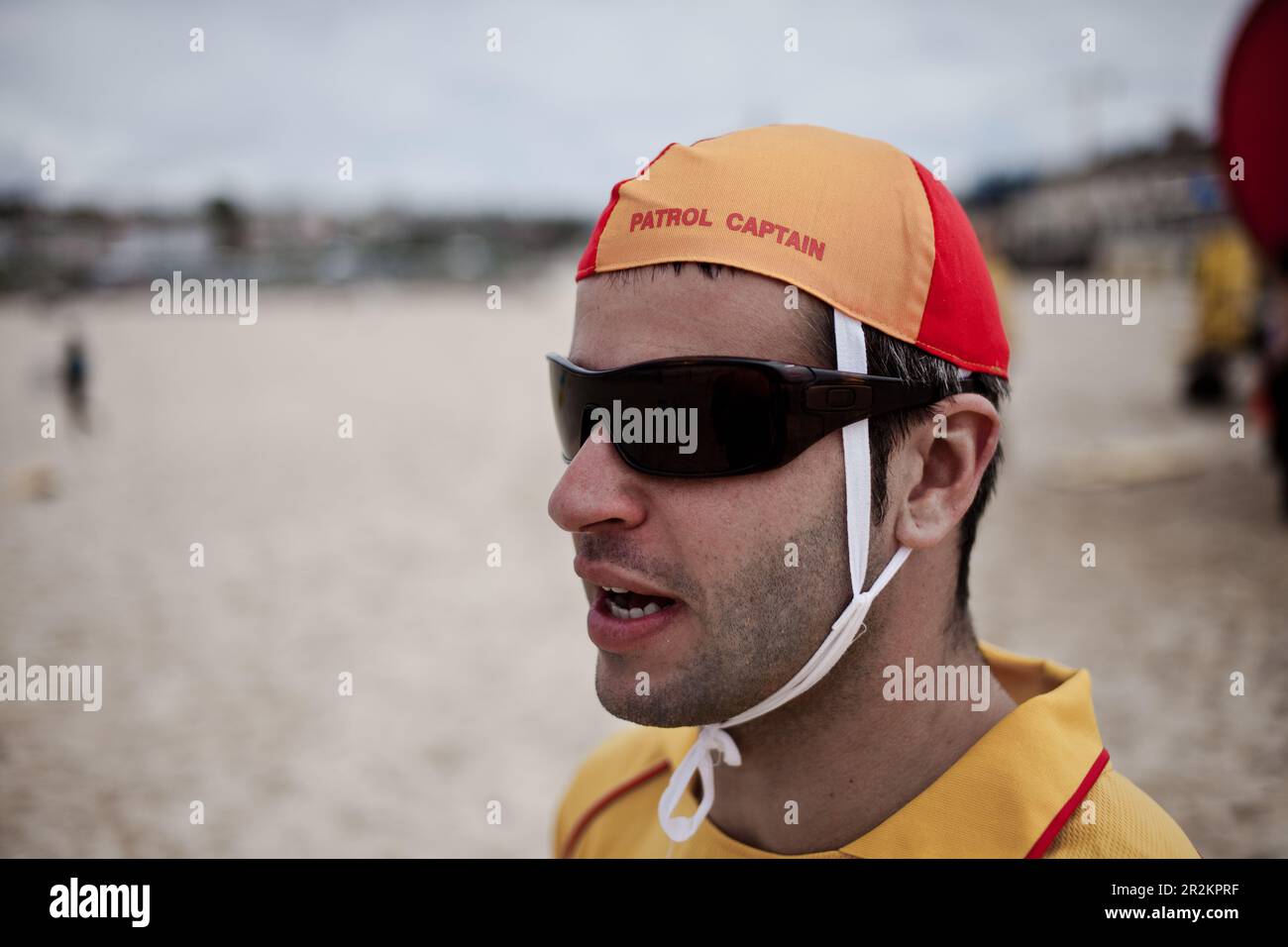A lifeguard wearing their characteristic hat, on duty at Bondi beach ...
